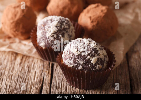 Dessert truffles sprinkled with cocoa on wooden table Stock Photo - Alamy