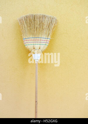 isolated country broom on yellow background Stock Photo - Alamy