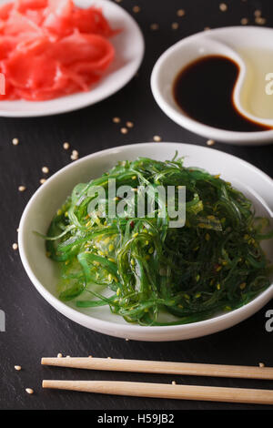 Plate with tasty seaweed salad on dark background with space for text ...
