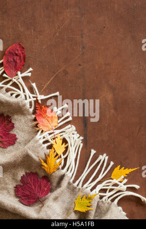 warm wool throw autumn red leaves on wooden background Stock Photo - Alamy