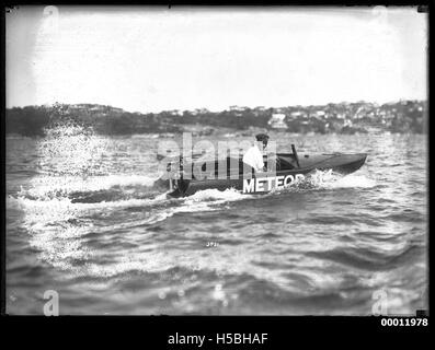 A speedboat is seen on Sydney Harbour with two men aboard. This image ...