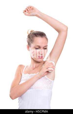 Girl applying stick deodorant in armpit. Young woman putting ...
