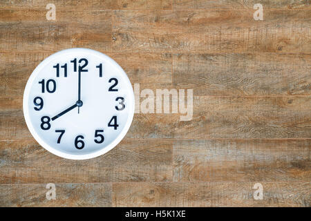 Wall clock show eight o'clock on white marble texture. Office clock ...
