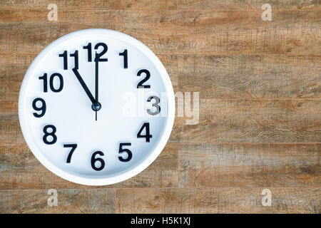 Clock show 11 am or pm and 30 minute on wood background with copy space ...