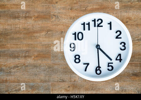 Wall clock show four o'clock on white marble texture. Office clock show ...
