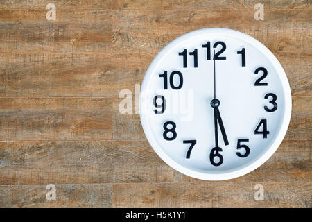 Wall clock show five o'clock on white marble texture. Office clock show ...