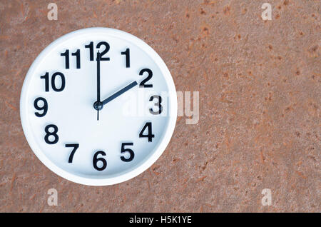 Wall clock show two o'clock on marble texture. Office clock show 2pm or ...
