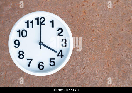 Wall clock show four o'clock on white marble texture. Office clock show ...