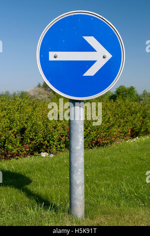 traffic sign indicating direction of travel at continental roundabout ...