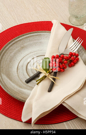 Christmas table place setting with silverware and dark natural ...