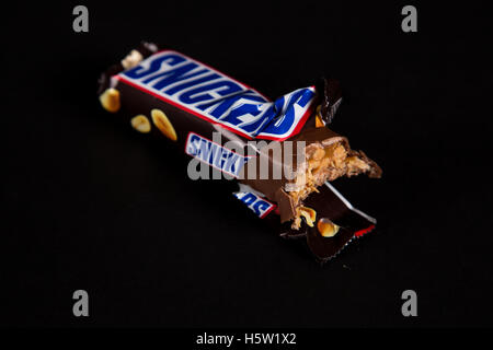 A Snickers chocolate bar unwrapped on a white background Stock Photo ...