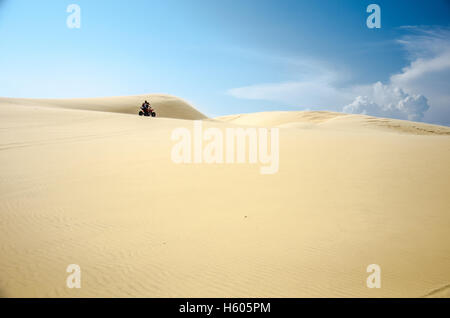 Quad biking through the desert at golden hour, Merzouga, Morocco Stock ...