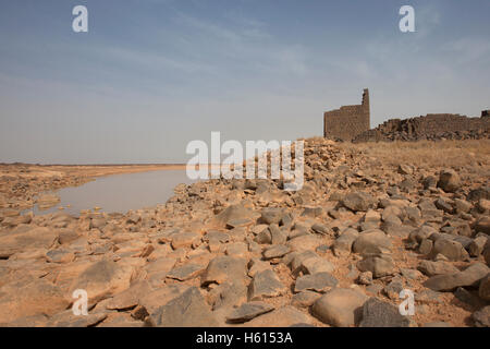 Black basalt stones surround ruins Qasr Burqu castle one of the ...