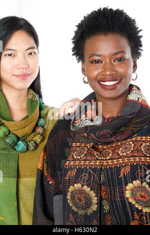 Two young adult women friends smiling and taking a selfie in a busy ...