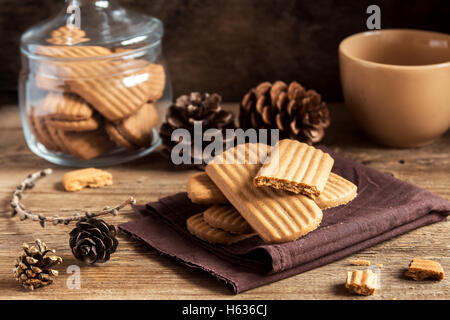 Plate with tasty homemade gingerbread cookies on dark concrete table ...