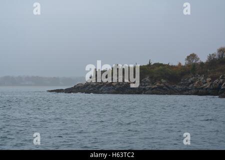 The rocky shoreline of Misery island and ruins in Salem Harbor, north ...