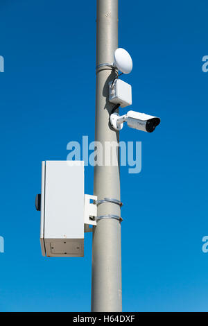 Security cctv cameras on pylon in blue background Stock Photo - Alamy