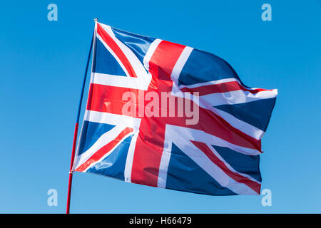 British flag waving in wind. in background of blue sky with white Stock ...