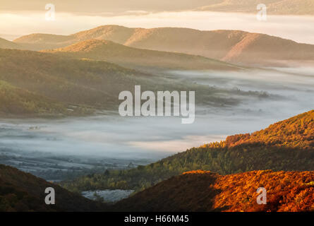 cold morning fog with red hot sunrise in the mountains in the morning ...