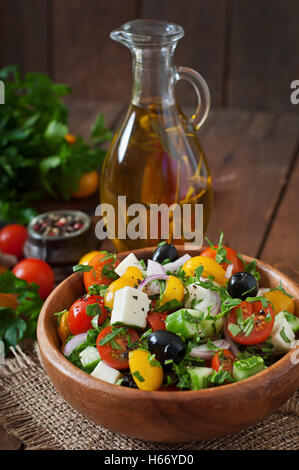 eating a Greek salad with feta cheese and pieces of dried rye bread ...