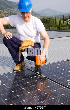 skilled woker fitting a photovoltaic plant on a roof Stock Photo - Alamy