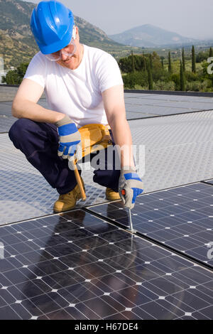skilled woker fitting a photovoltaic plant on a roof Stock Photo - Alamy