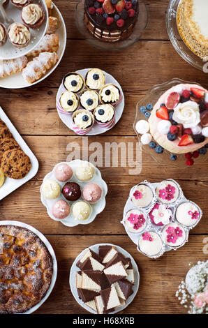 Table with loads of cakes, cupcakes, cookies and cakepops Stock Photo ...