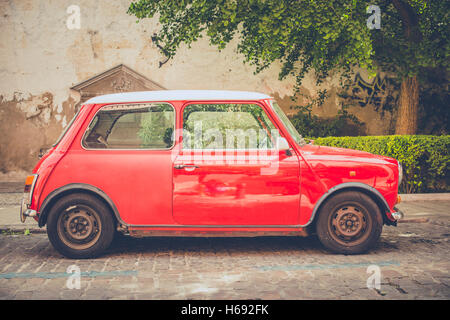 Vintage small red car on the street Stock Photo - Alamy