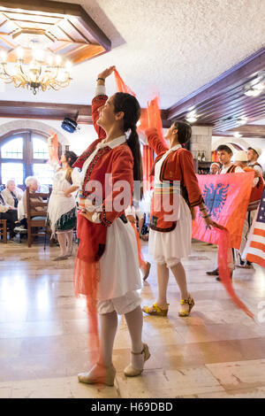 People dressed in costumes perform outside the venue of the African ...