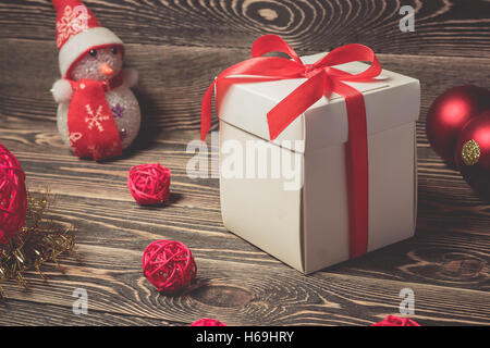Brown gift box and Christmas presents on white wooden table background ...