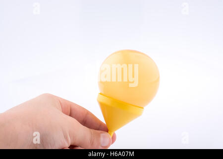 Balloon in a funnel on white background Stock Photo - Alamy