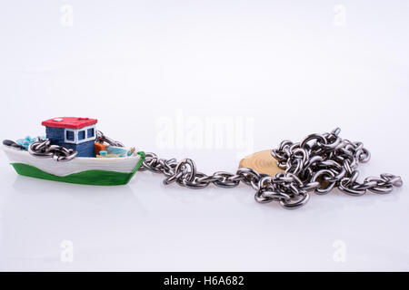 Little colorful model boat with chains on white background Stock Photo ...