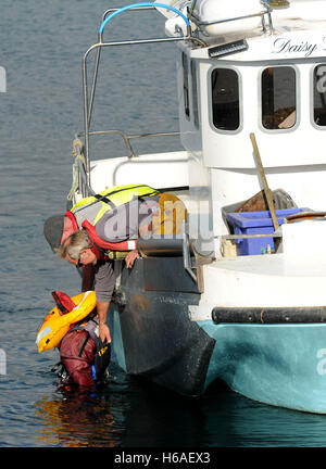 Fishermen practice a man overboard rescue exercise, Weymouth, Dorset ...