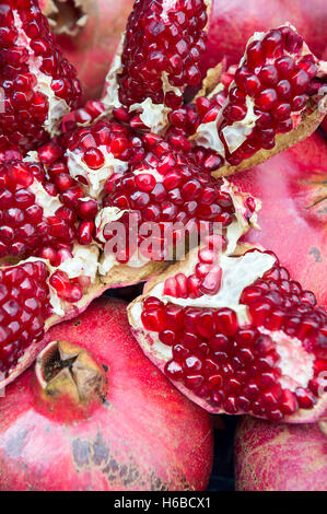 Fresh pomegranate split open to reveal the seeds on display at a ...
