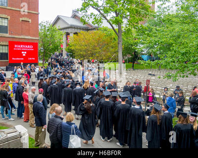 Wearing graduation caps and gowns, multiracial Harvard University ...
