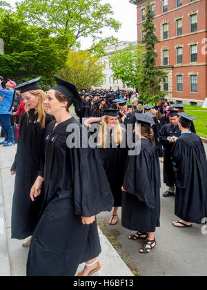 Wearing graduation caps and gowns, multiracial Harvard University ...