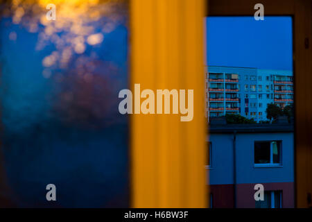 Tungsten lighting reflecting off a bumpy window, with another window in ...