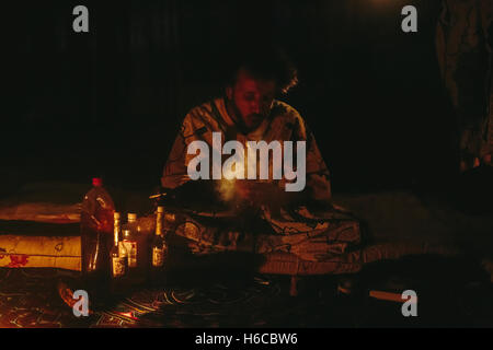 A Shipibo curandero shaman holds a cup of Ayahuasca an indigenous ...