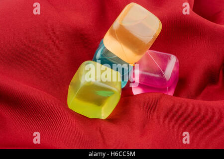 Fake ice cubes in color on a colorful fabric background Stock Photo - Alamy