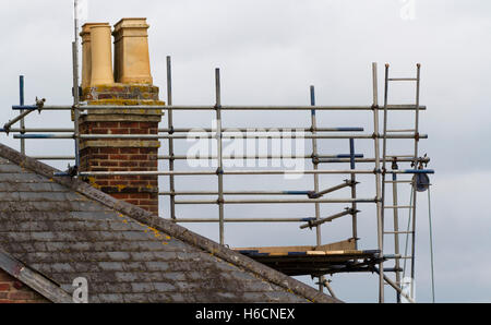 Scaffolding around a chimney stack on a slate roof Stock Photo - Alamy