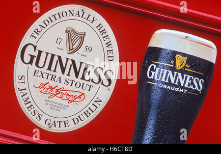 Irish pub with Guinness ad poster in both Gaelic and English, Kilkenny ...