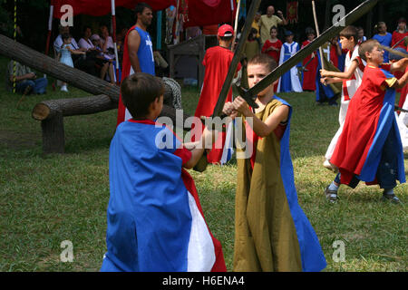 Boys at medieval themed summer camp pretending to sword fight Stock ...