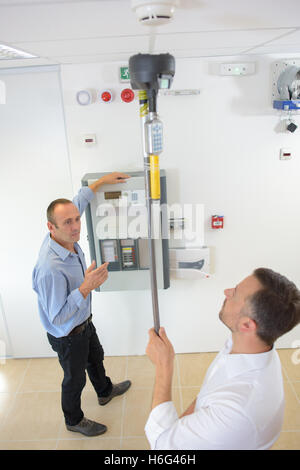 Man testing smoke detector Stock Photo - Alamy