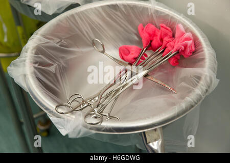 Used swabs in a dish in an operating theatre during an operation at an ...