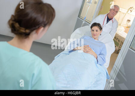 nurse transferring the patient to the recovery room Stock Photo - Alamy
