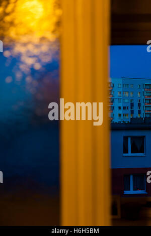 Tungsten lighting reflecting off a bumpy window, with another window in ...