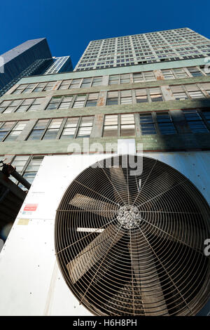 Wide angle view at an outdoor HVAC air conditioner unit located on a ...