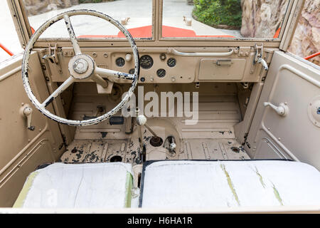 interior dashboard of a rusty old car in a junk yard in the desert in ...