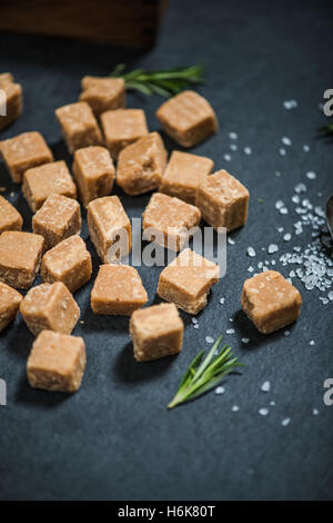Sea Salt and Caramel Fudge on a Wooden Table with Baking Paper Stock ...