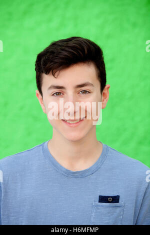 Portrait of a teenager rebellious man with a green background Stock ...